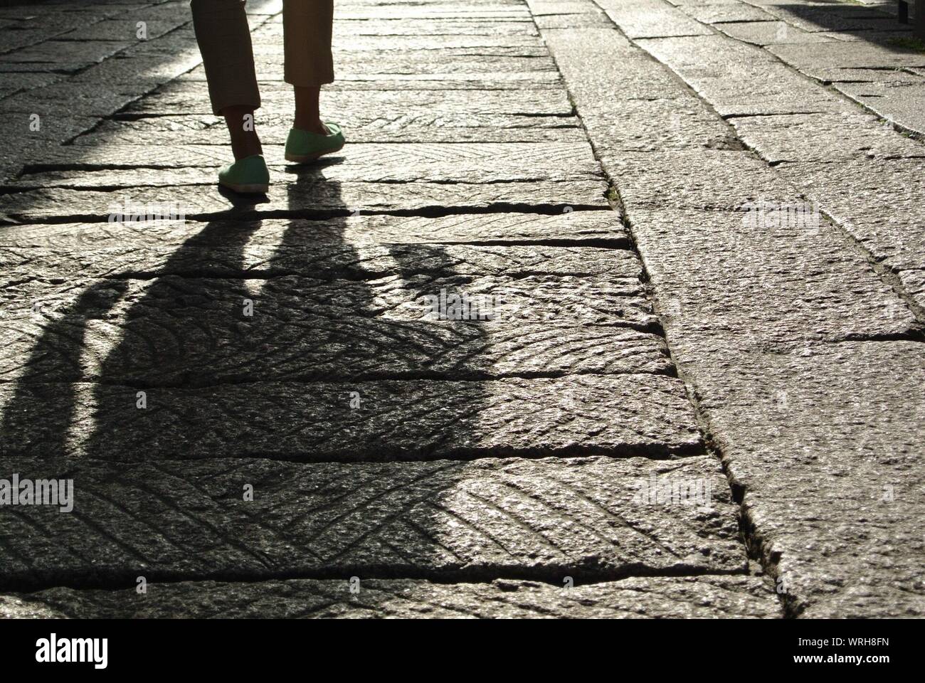 Man walking on paving hi-res stock photography and images - Alamy
