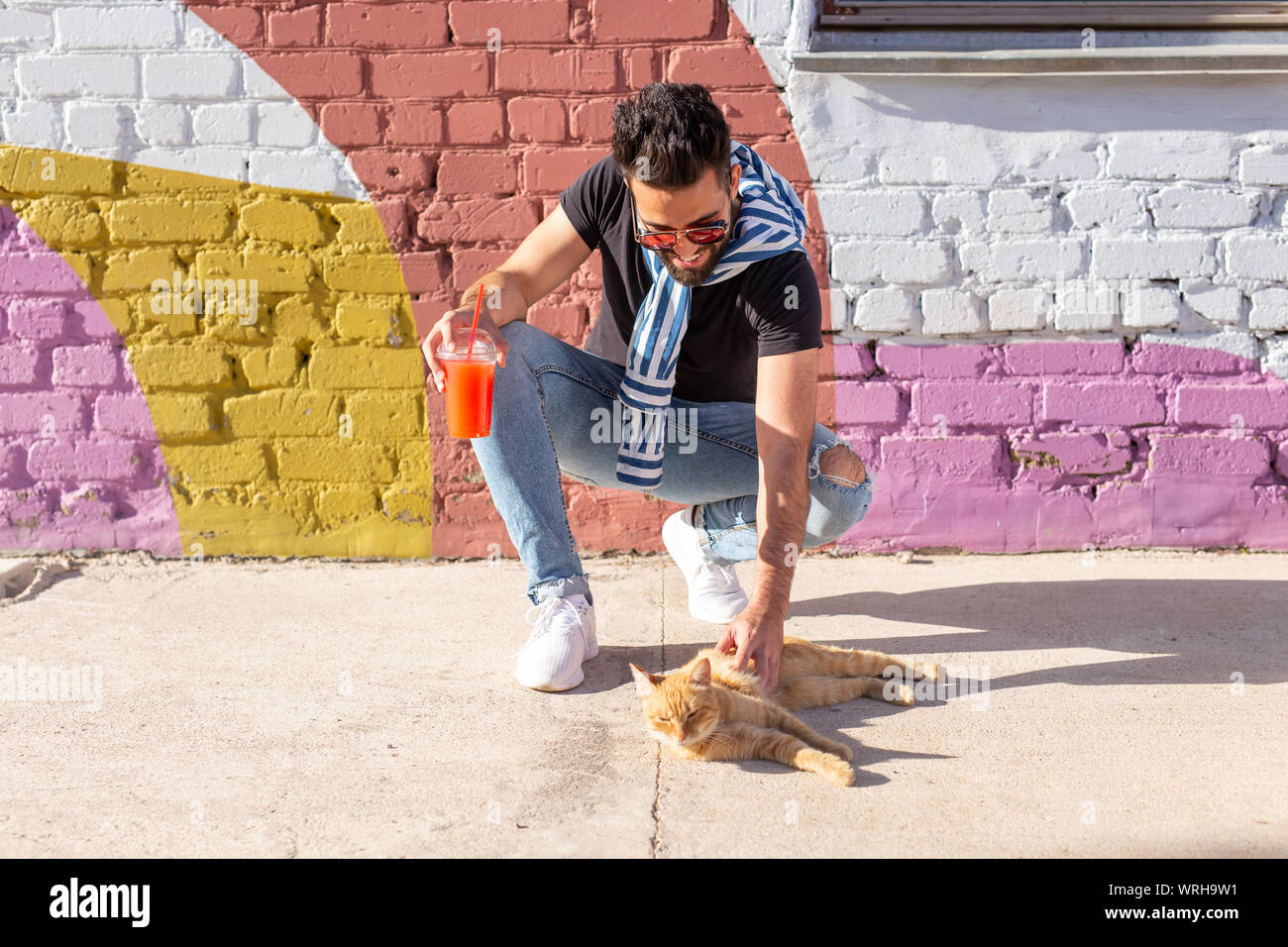 Pet owner and friendship concept - Handsome man is holding and hugging ...