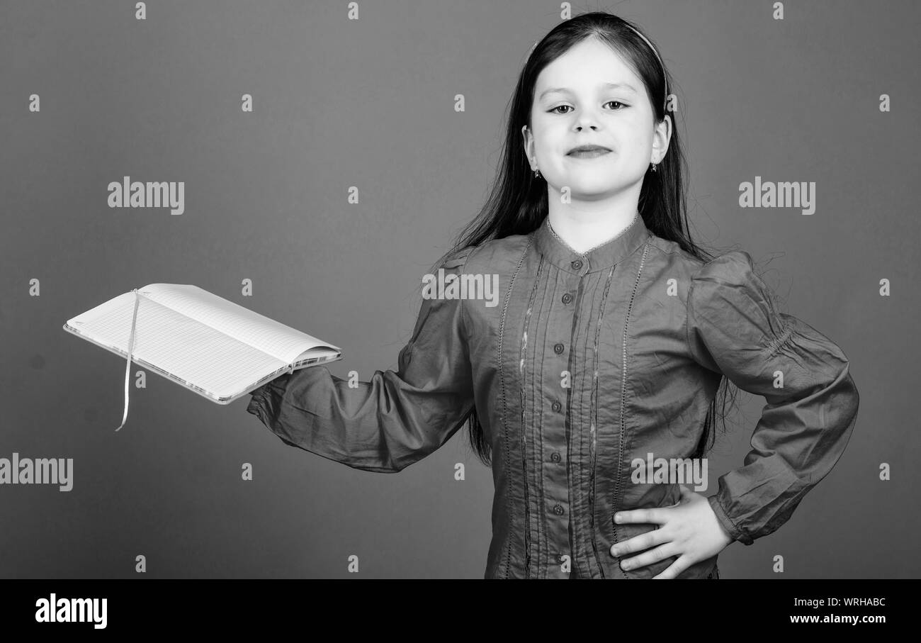 The library is the temple of learning. Confident small child holding ...