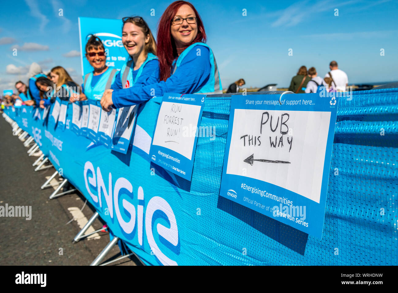 Race supporters out to cheer competitors with banners and signs at the ...