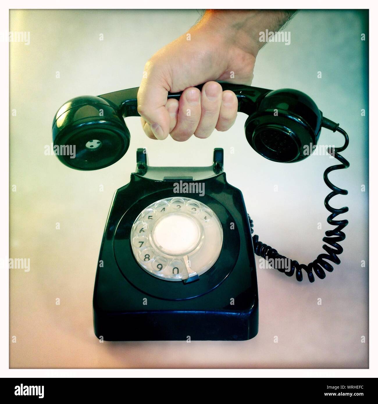 Hand holding old phone receiver hi-res stock photography and images - Alamy