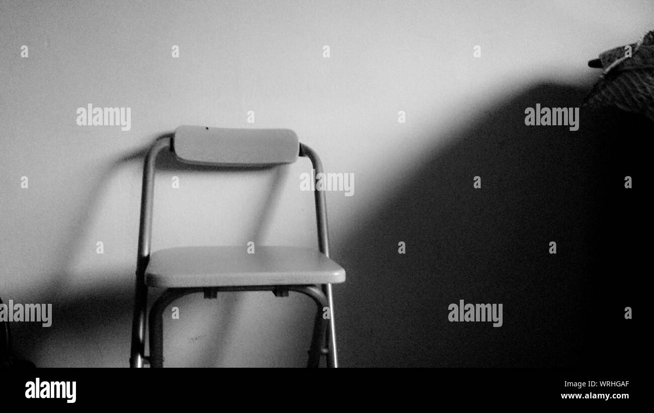 Chair against a wall hi-res stock photography and images - Alamy