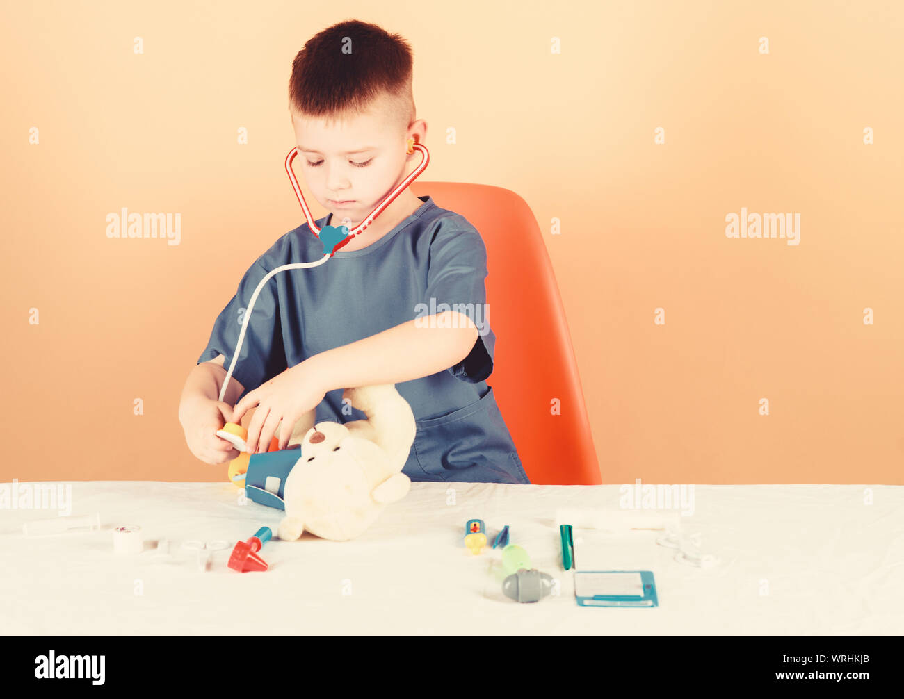 pediatrician intern. little boy in medical uniform. kid doctor with ...