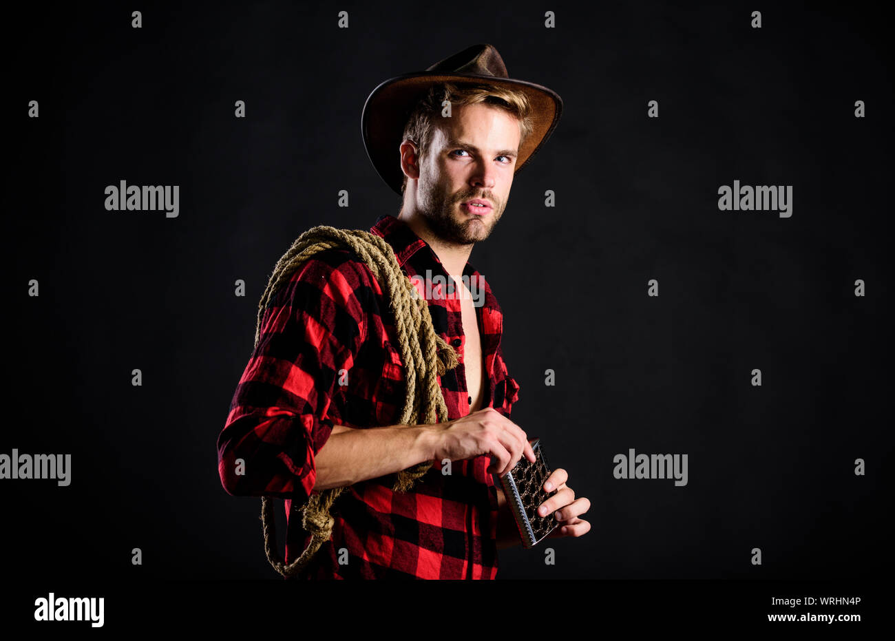 Western culture. Man handsome unshaven cowboy black background. Western ...