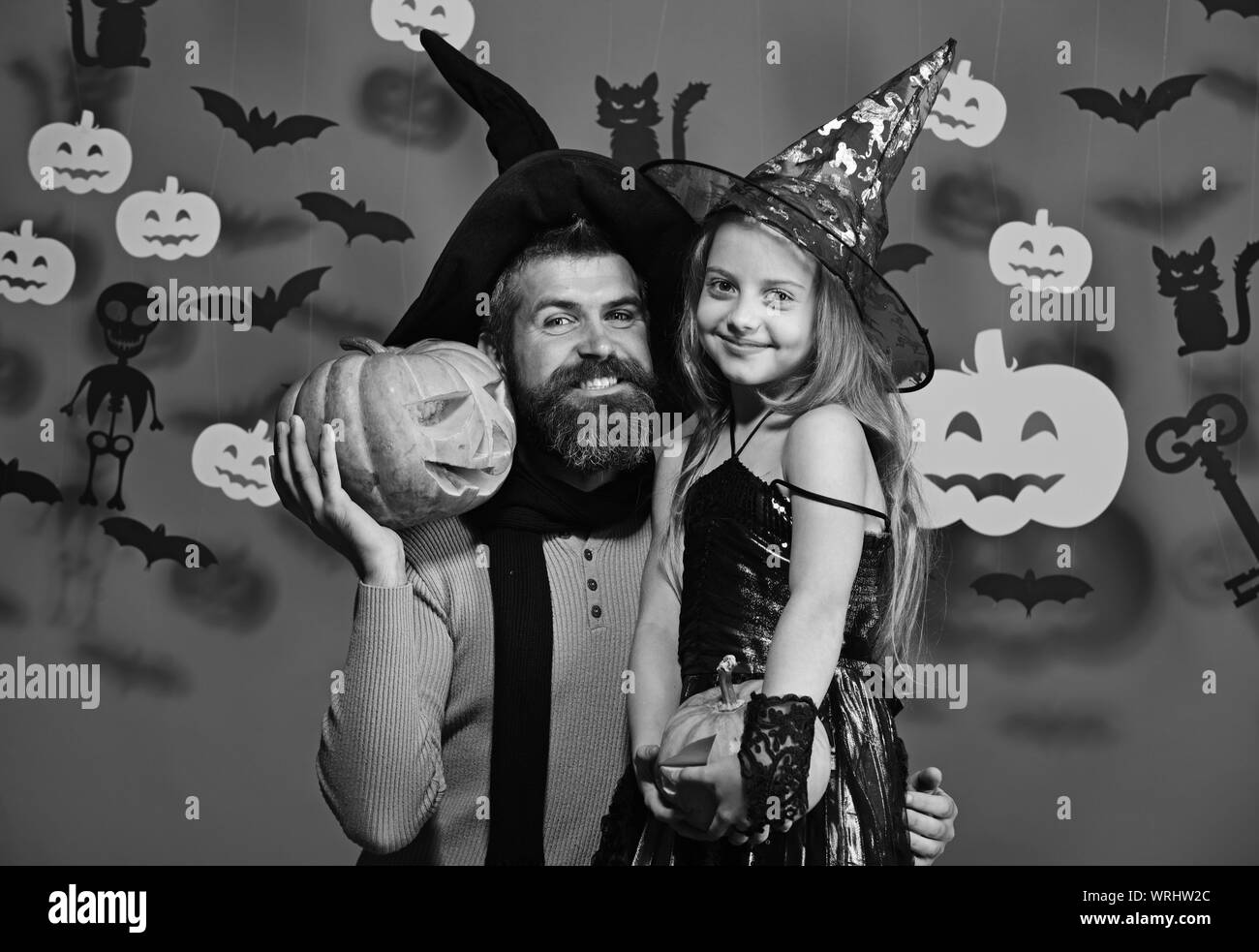 Dad and daughter in costumes. Girl and bearded man with smiling faces ...