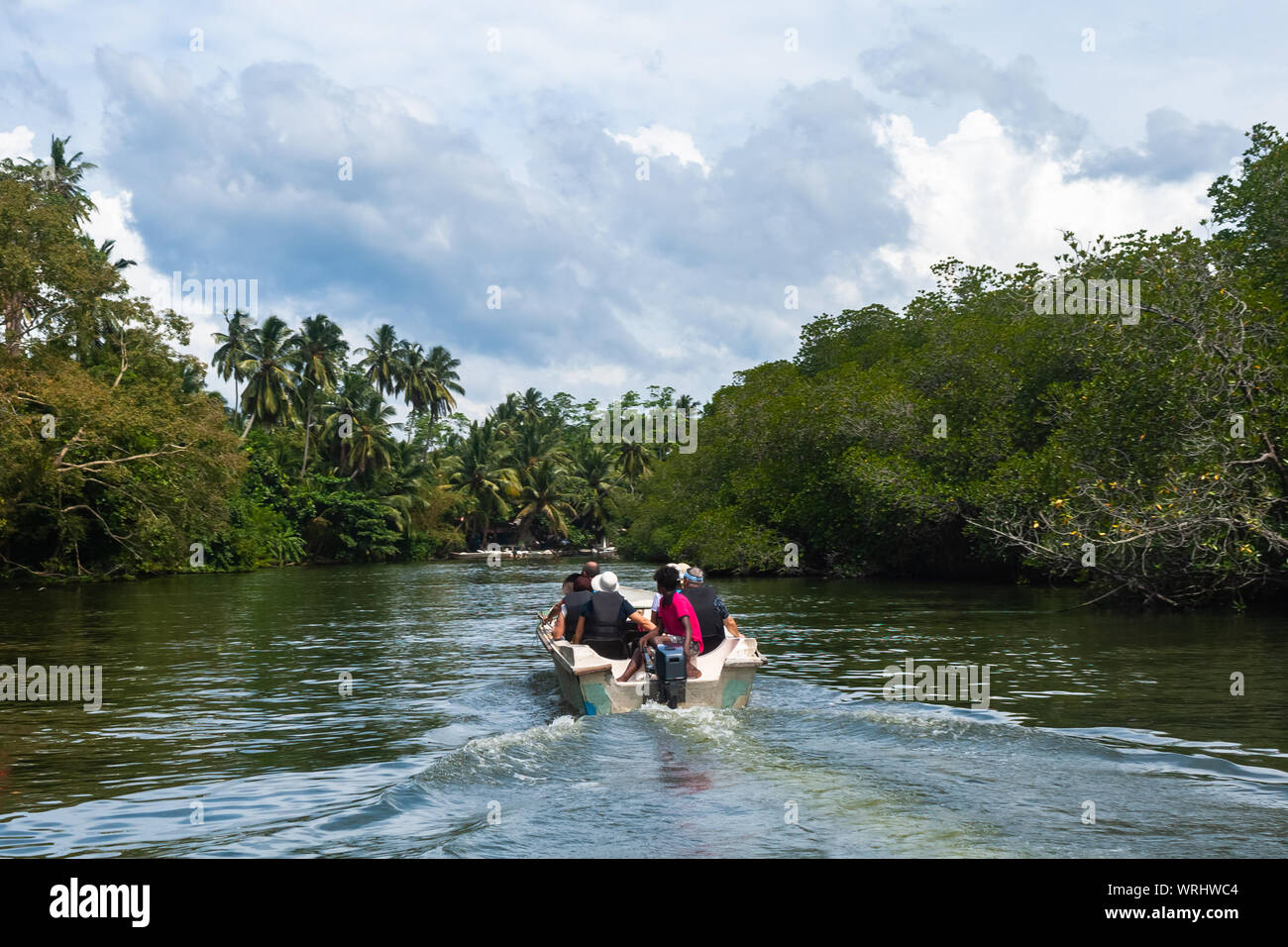 boat with people. Madu River Safari Stock Photo - Alamy