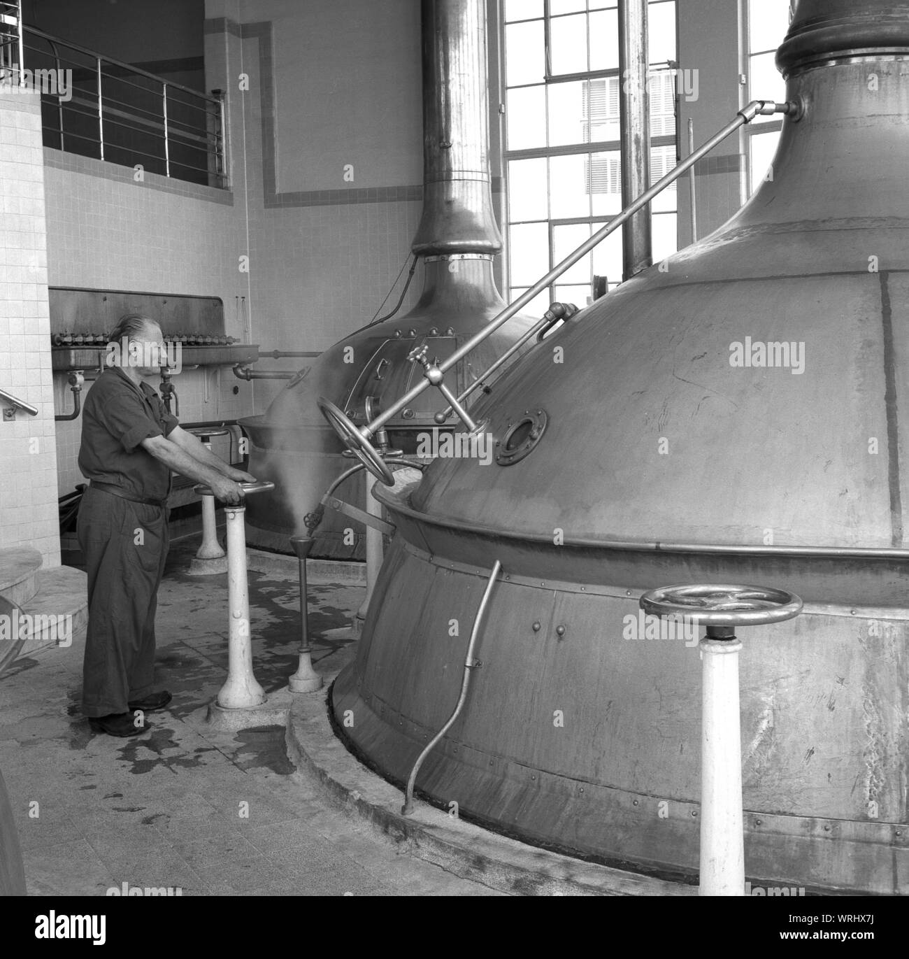 1950s, historical, worker inside a whisky factory operating the ...