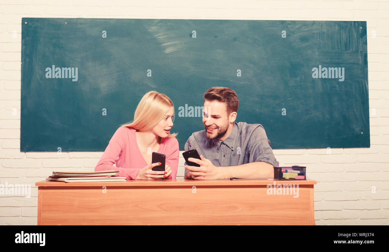 Look at this. Back to school. Couple of man and woman in classroom ...