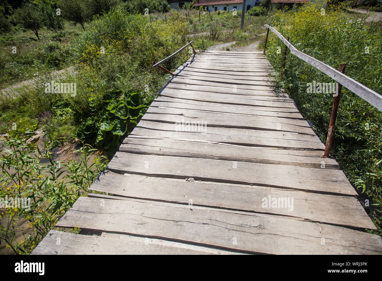 Old ruined wooden bridge at rural landscape on natural light at summer ...