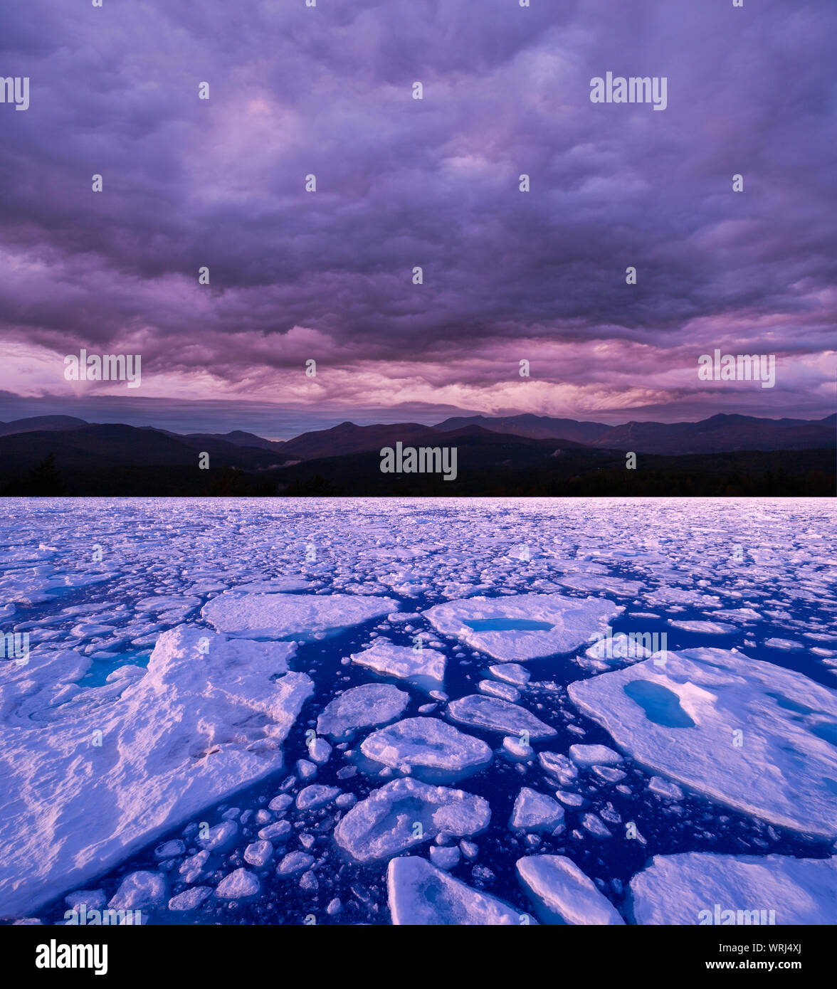 Digital composite of stormy clouds over frozen field of ice floats ...