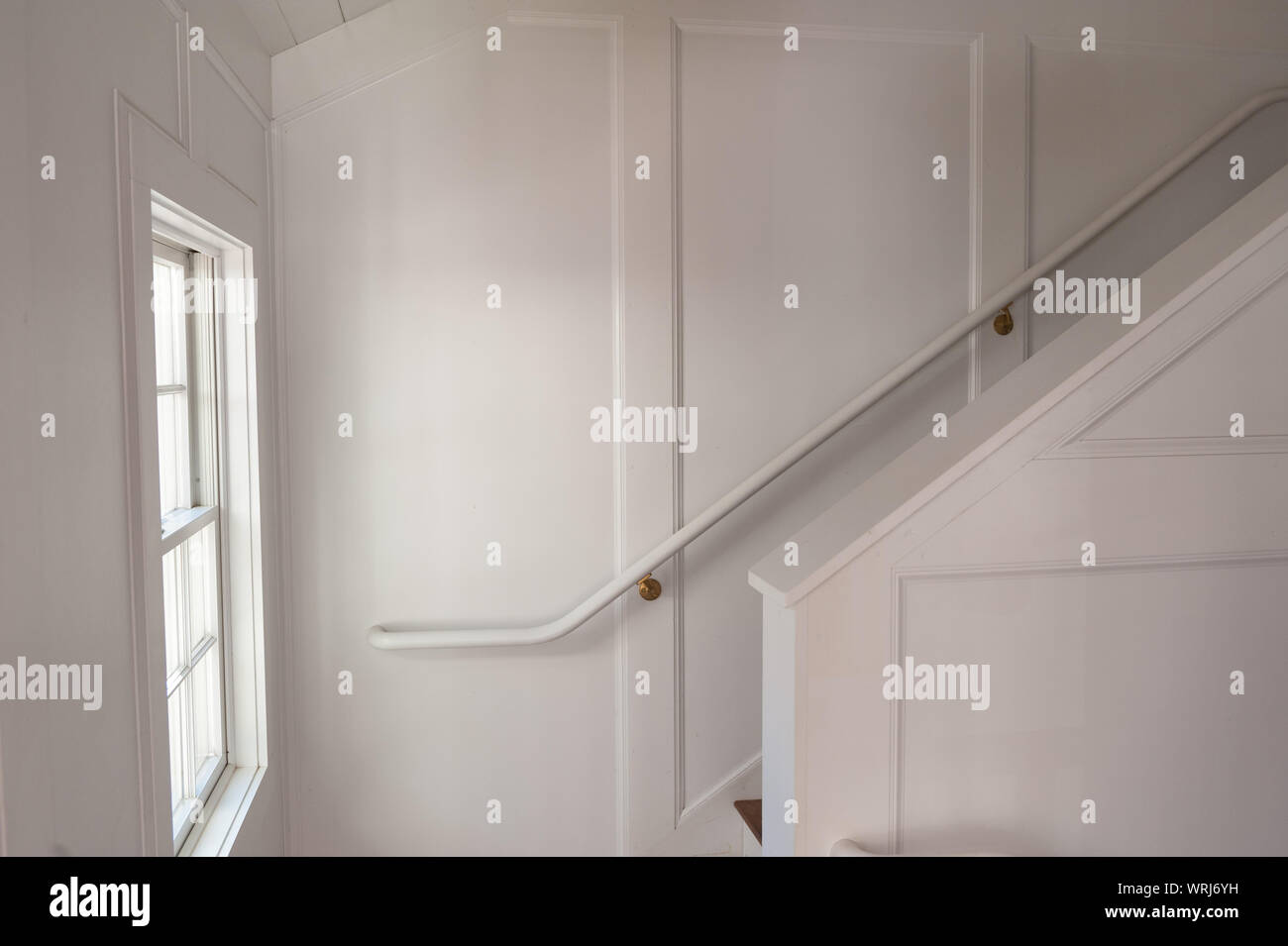 Daylight streaming in a window onto stairs in a white room Stock Photo ...