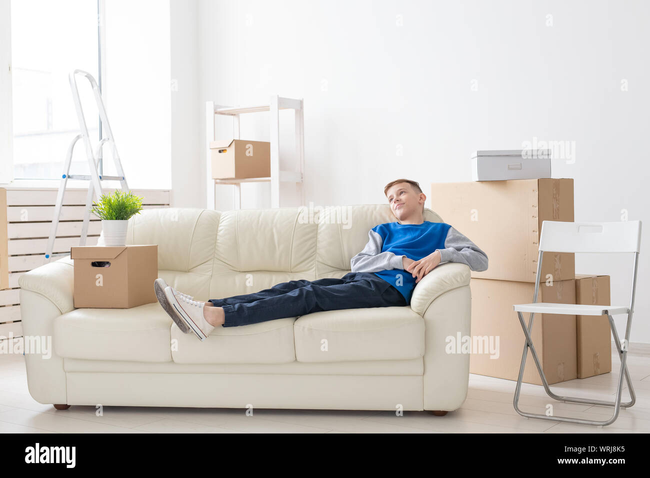 Relocation, new house and children concept - Satisfied happy teen boy ...