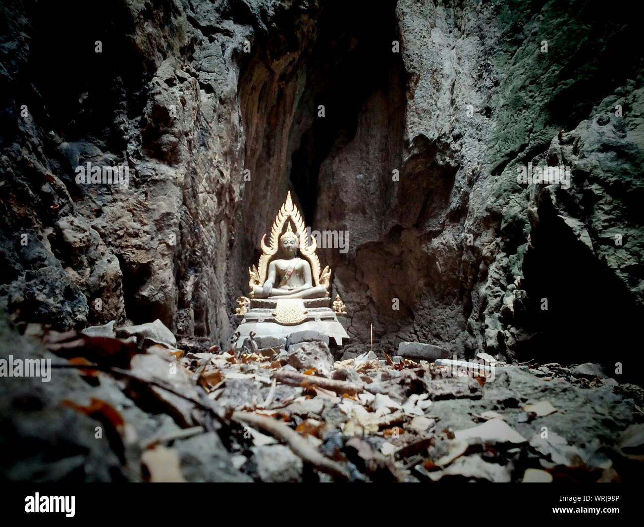 God Statue Amidst Rocks Stock Photo - Alamy