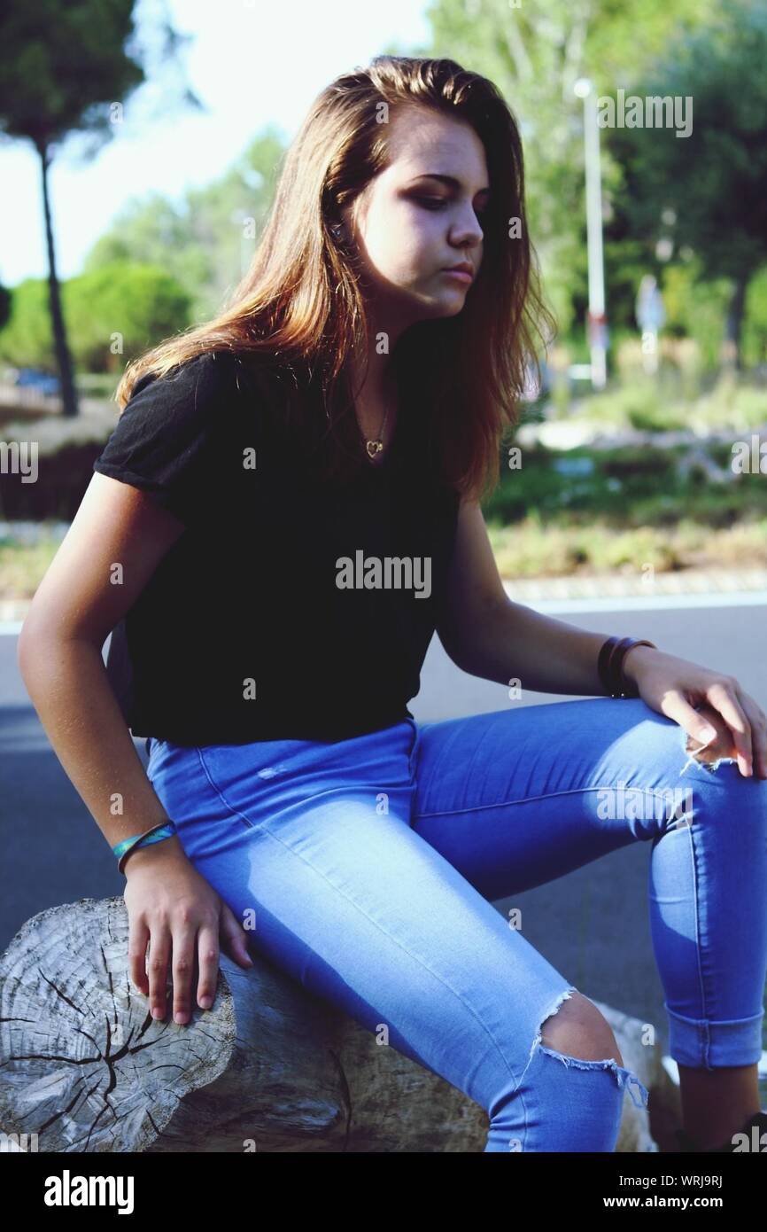 Woman sitting on log hi-res stock photography and images - Alamy