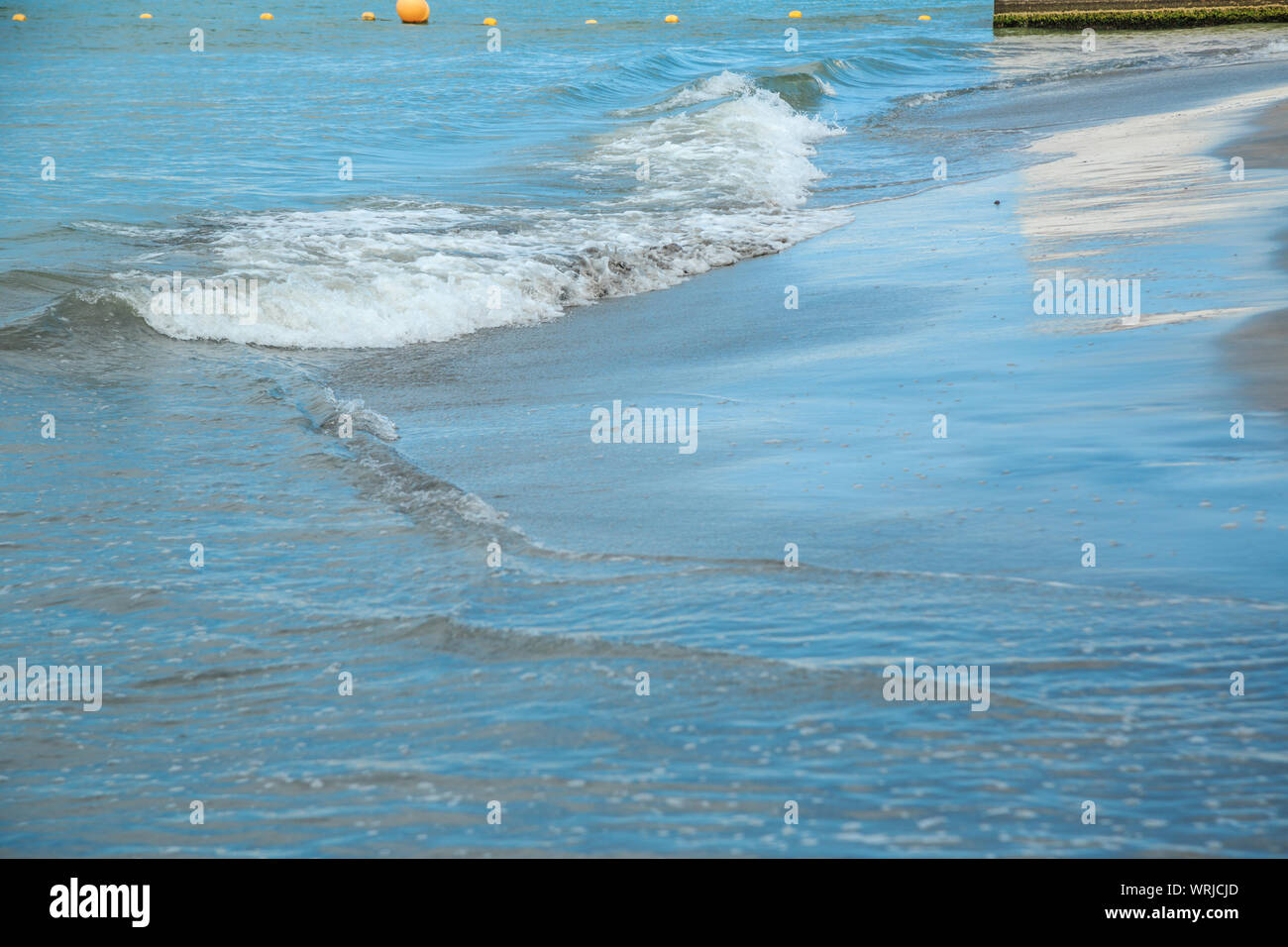 background of waves beating on a sandy beach in stormy weather Stock ...
