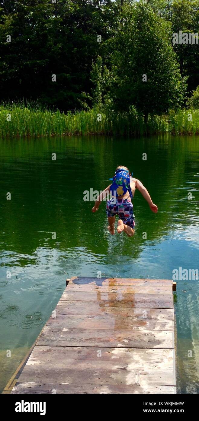 Boy jumping river hi-res stock photography and images - Alamy