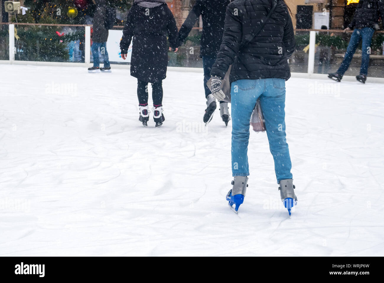 Closeup view of ice skates on outdoor ice rink for habitants. Ice ...