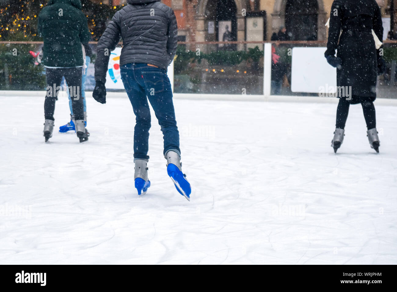 Closeup view of ice skates on outdoor ice rink for habitants. Ice ...
