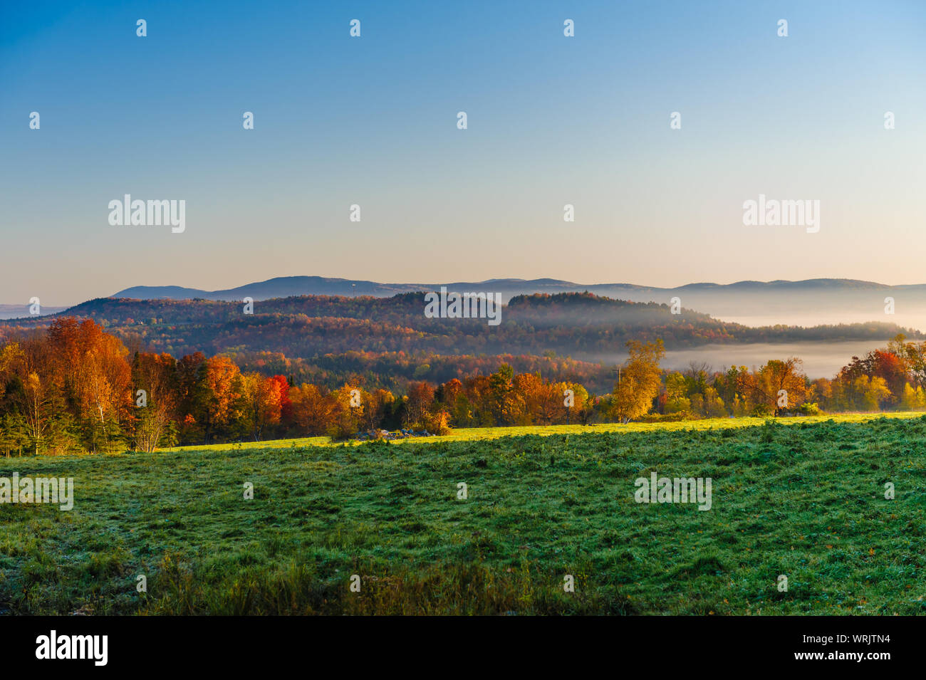 Landscape view of a morning sunrise during fall foliage season, Stowe ...