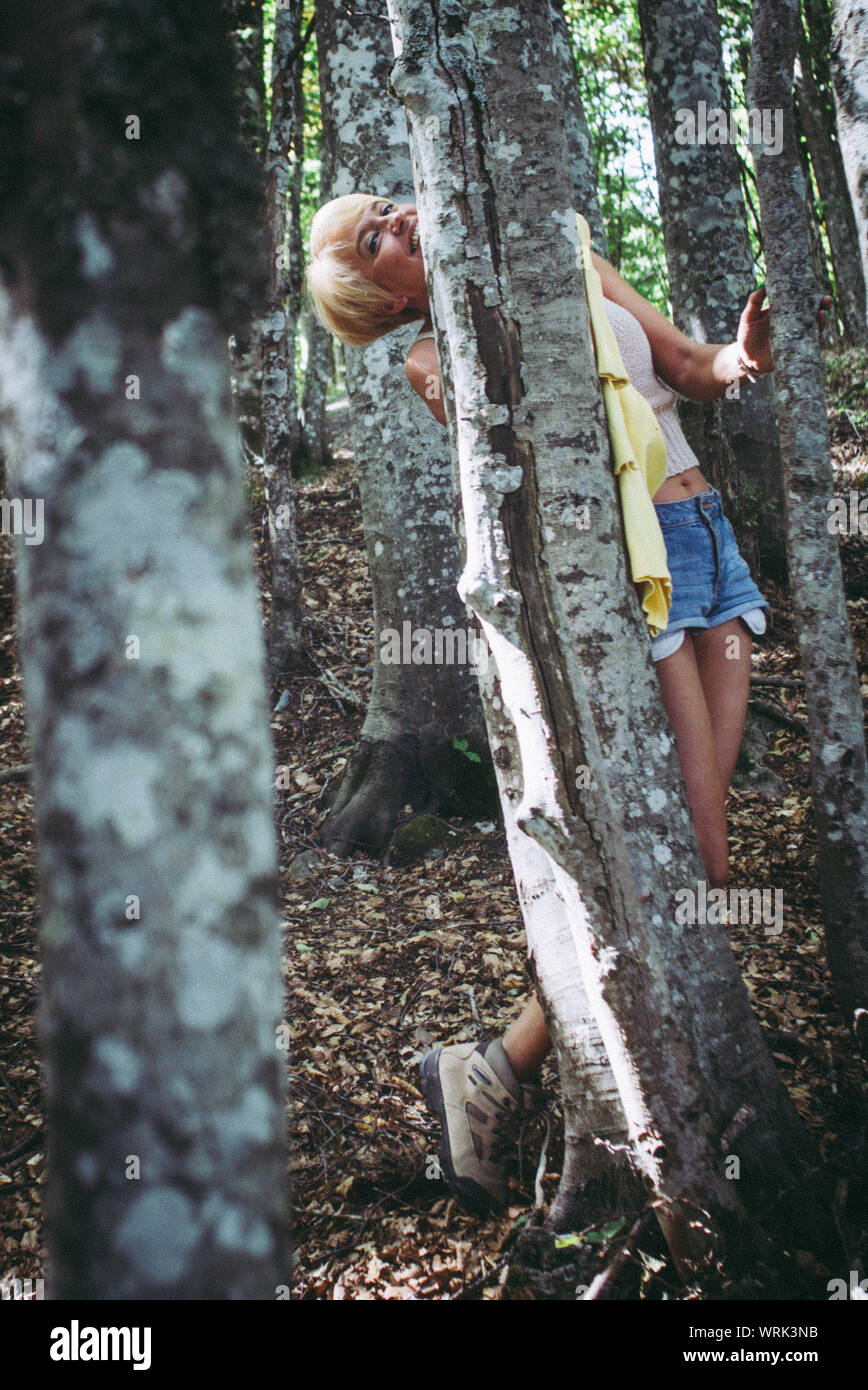 Woman hiding in the forest hi-res stock photography and images - Alamy