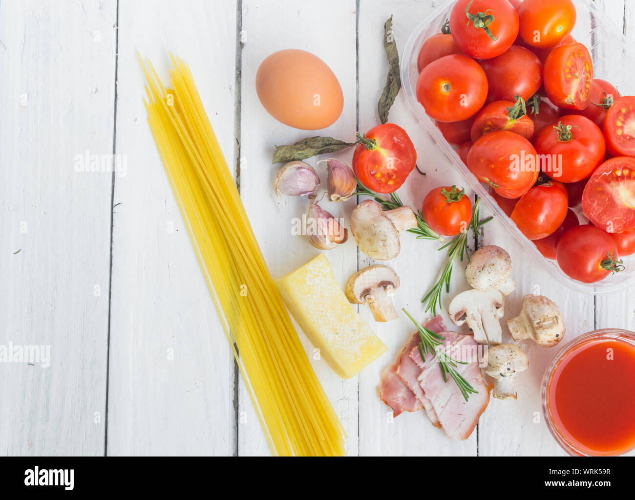 Frame with spaghetti and various ingredients for cooking pasta on a ...