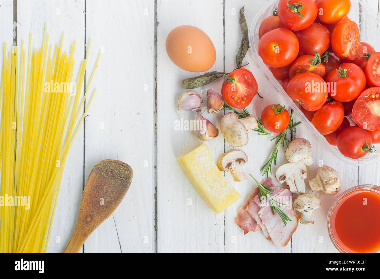 Frame with spaghetti and various ingredients for cooking pasta on a ...