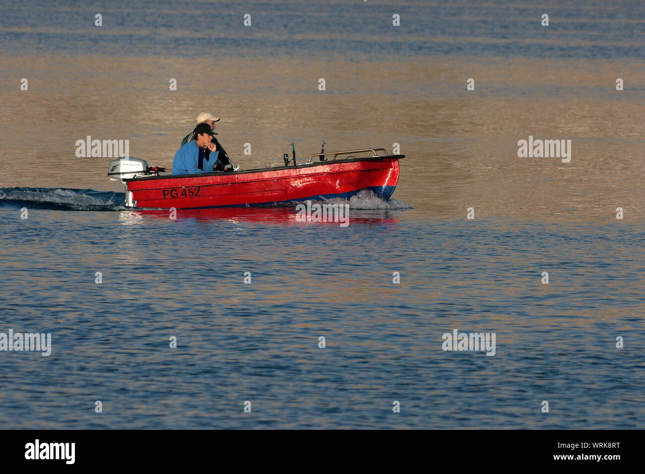 red boat in the sea Stock Photo - Alamy