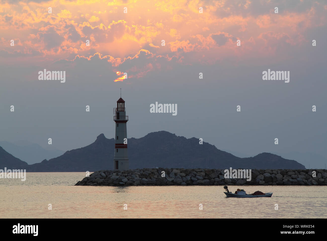 Seascape at sunset. Lighthouse on the coast. Seaside town of Turgutreis ...