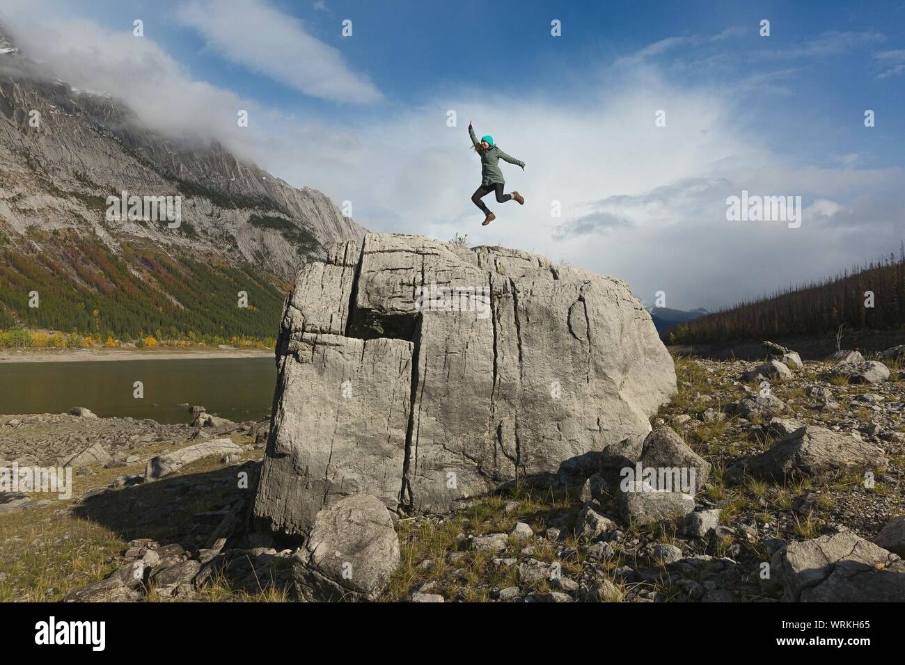 Woman jumping rock formation hi-res stock photography and images - Alamy
