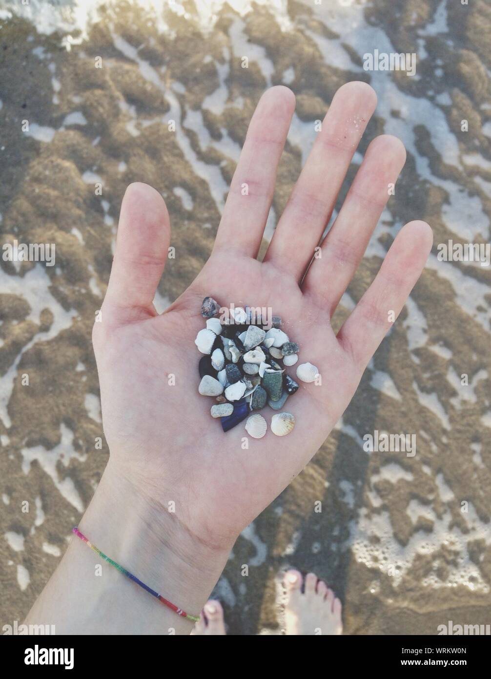 Pebble in hand beach hi-res stock photography and images - Alamy