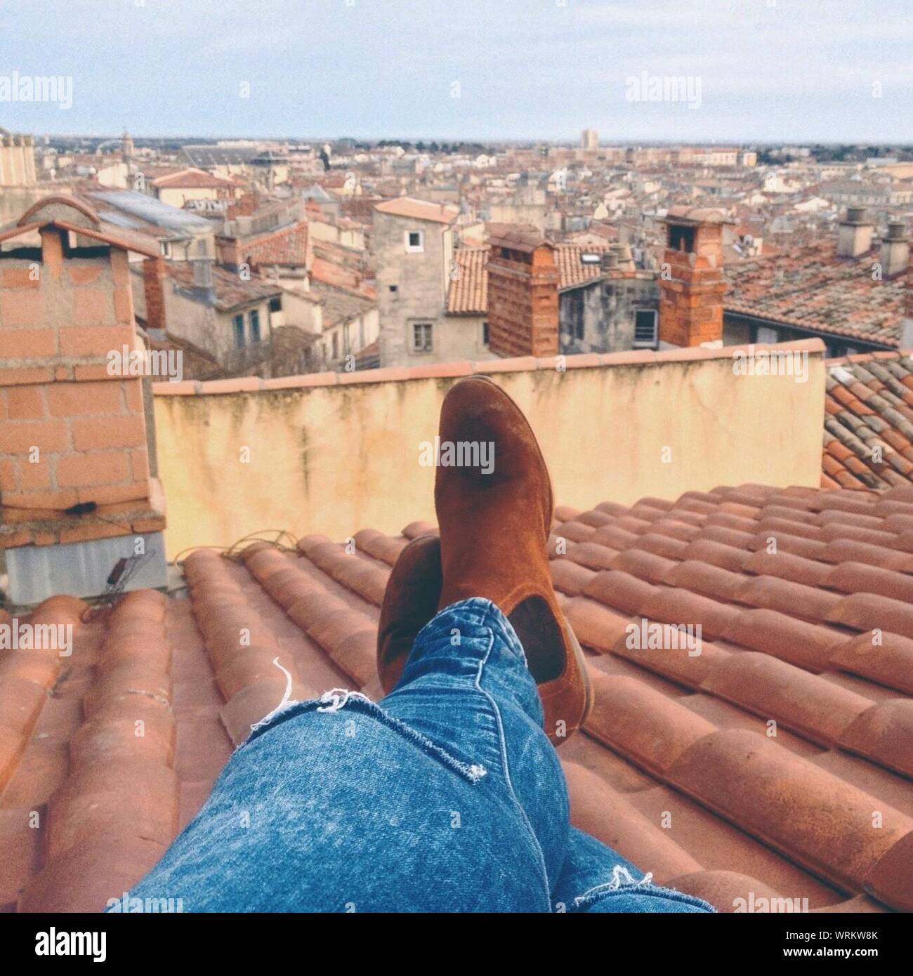 Man sitting on roof hi-res stock photography and images - Alamy