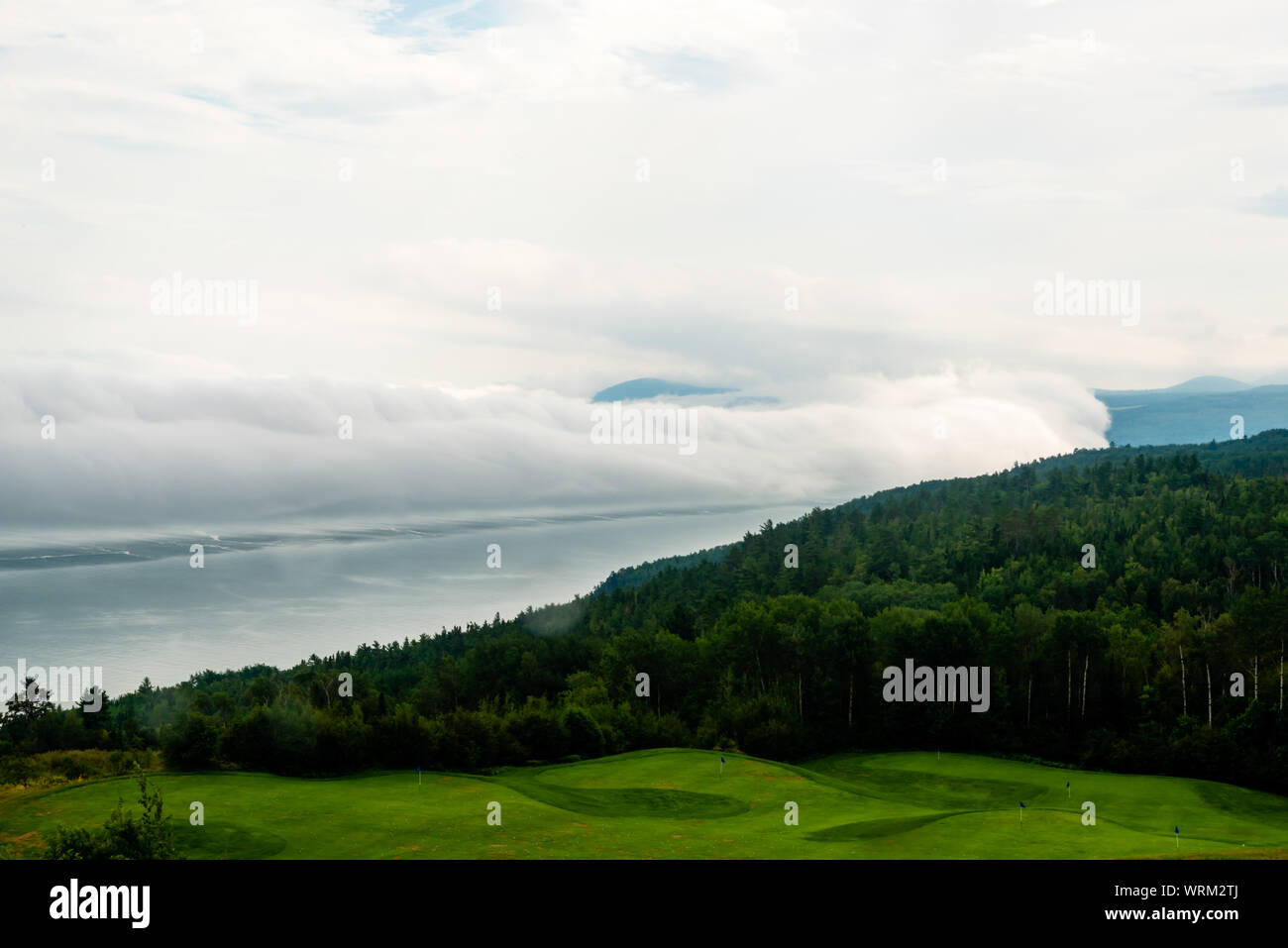Foggy day by the St-Laurent river, golf field Stock Photo - Alamy