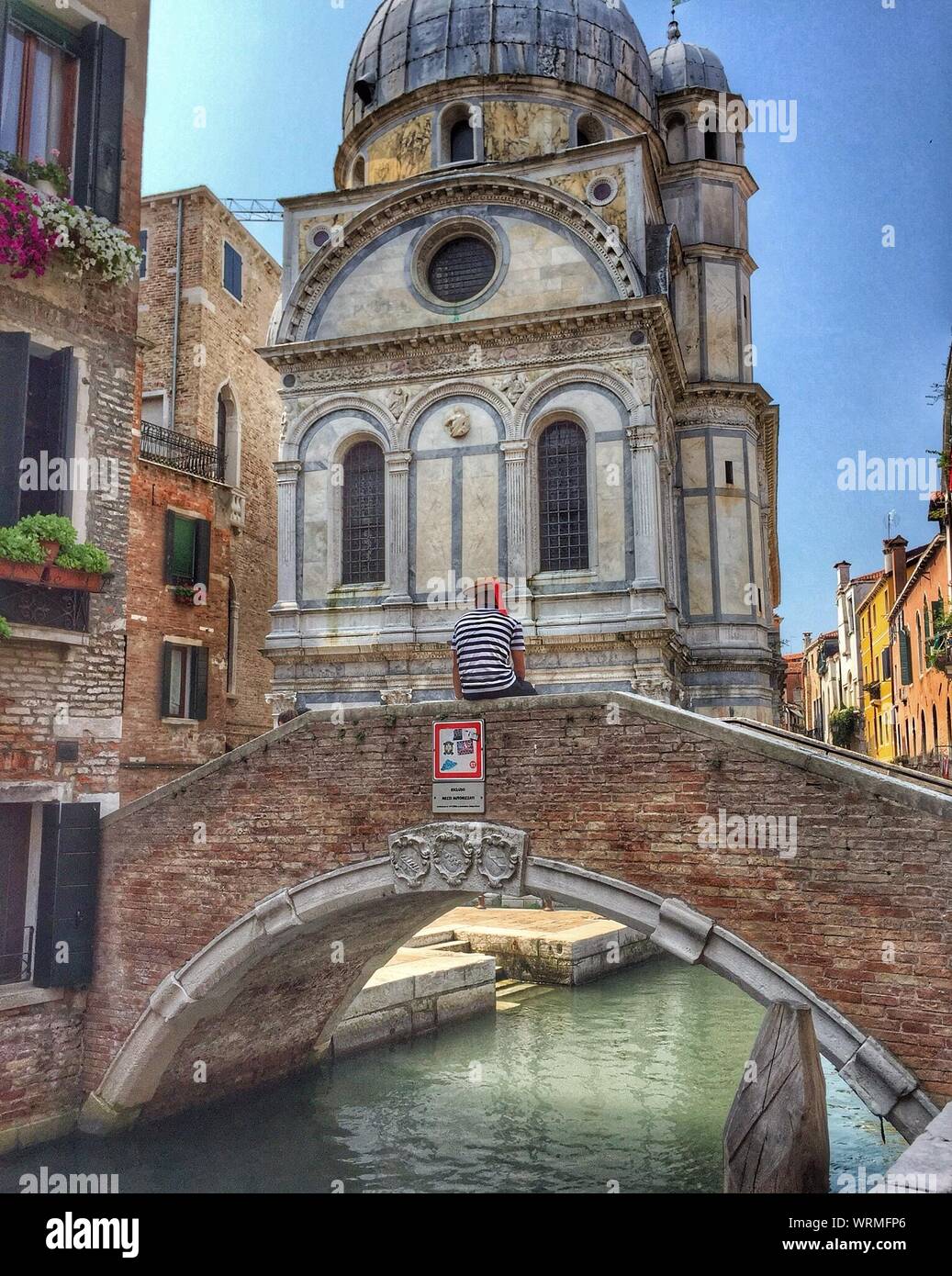 Man Sitting On Bridge Over Canal In Venice Stock Photo - Alamy