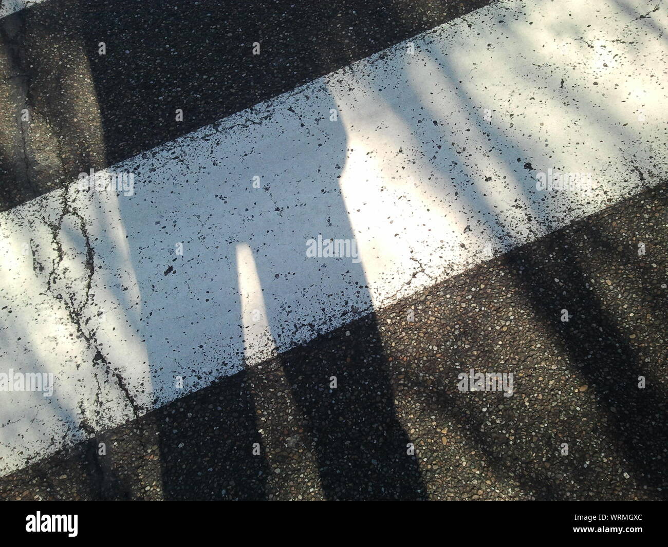 Person shadow road marking asphalt hi-res stock photography and images ...