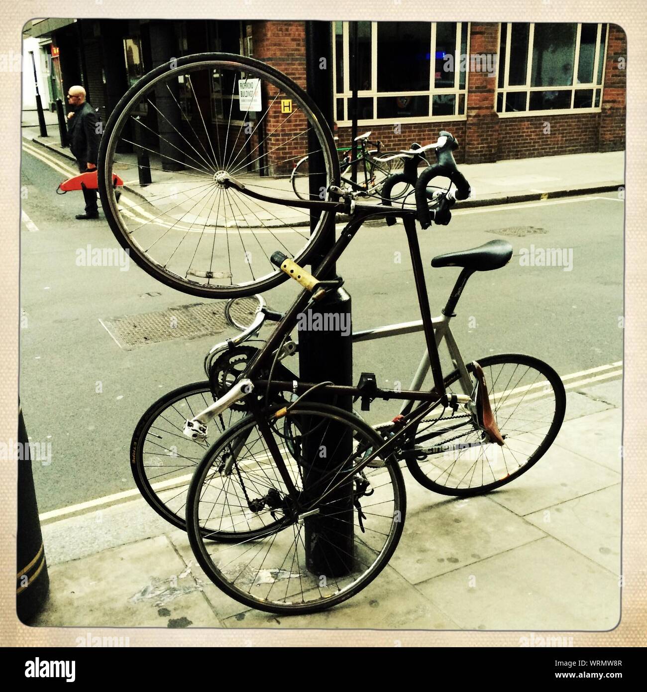 Bicycle chained to pole hi-res stock photography and images - Alamy