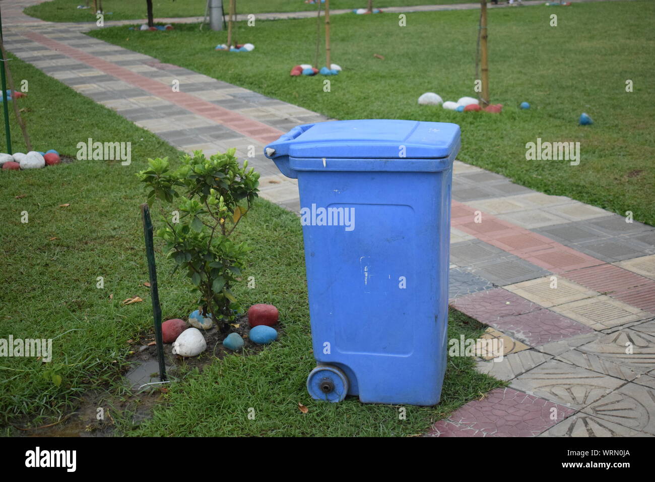 Blue colour dustbin in a park for clean outdoor and environment Stock ...