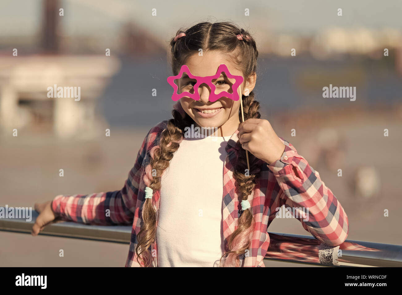 Aint it funny. Little girl looking through funny star shaped glasses on ...