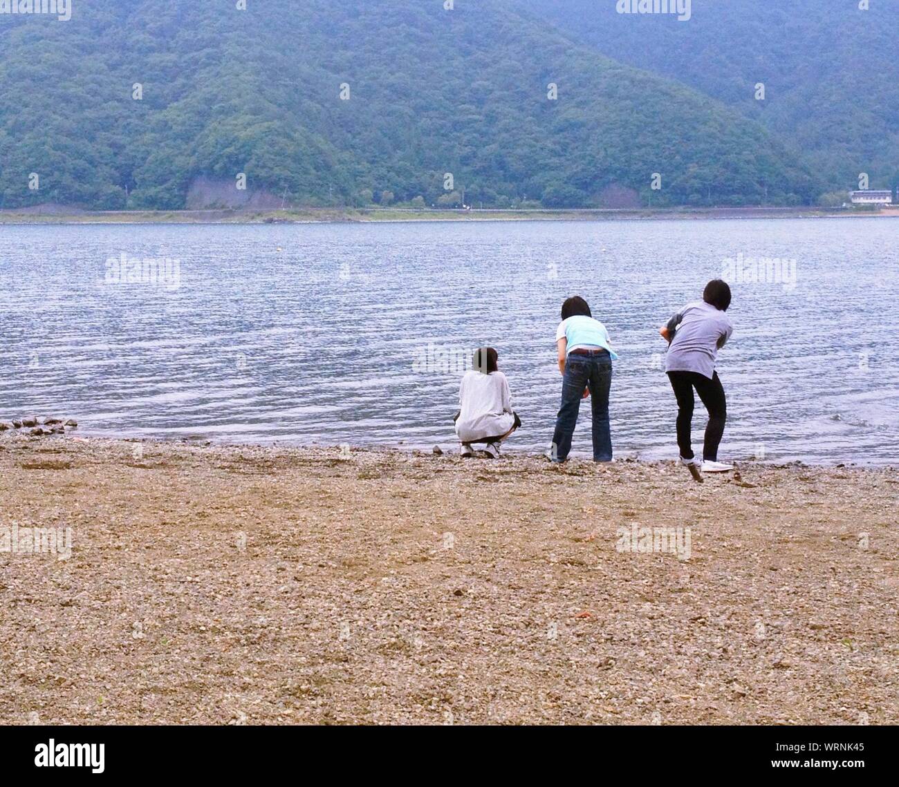 Three women on the beach hi-res stock photography and images - Alamy