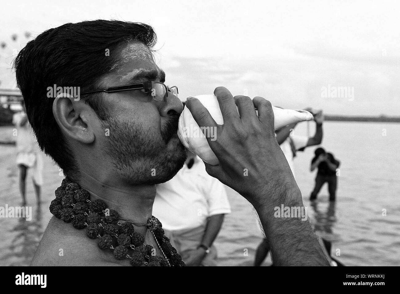 Man blowing shell hi-res stock photography and images - Alamy