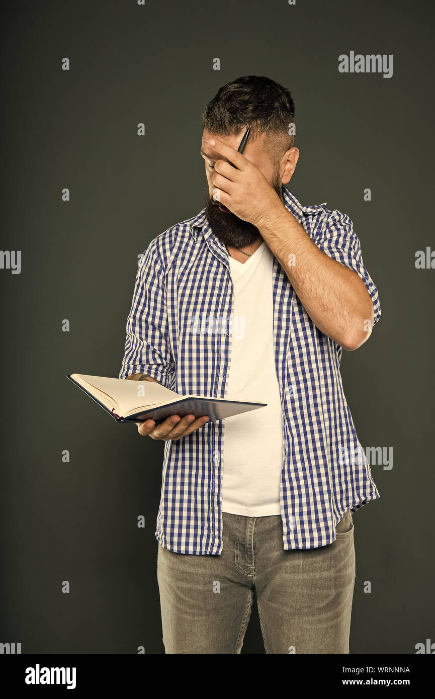 Keep reading, knowledge is power. Bearded man reading book on grey ...