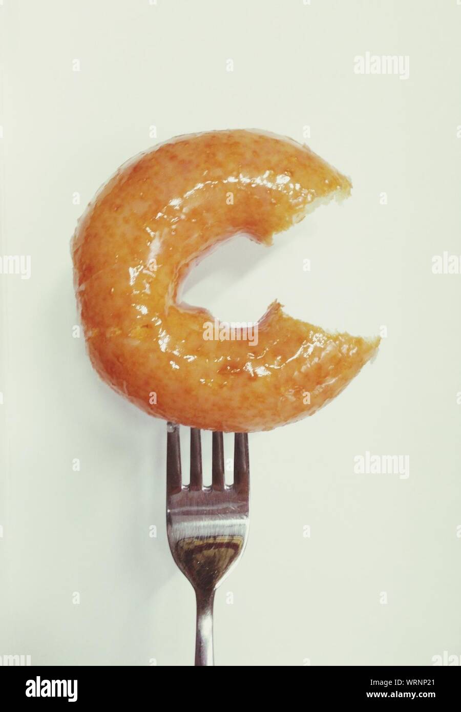 Donut With Missing Bite On Fork Against White Background Stock Photo ...