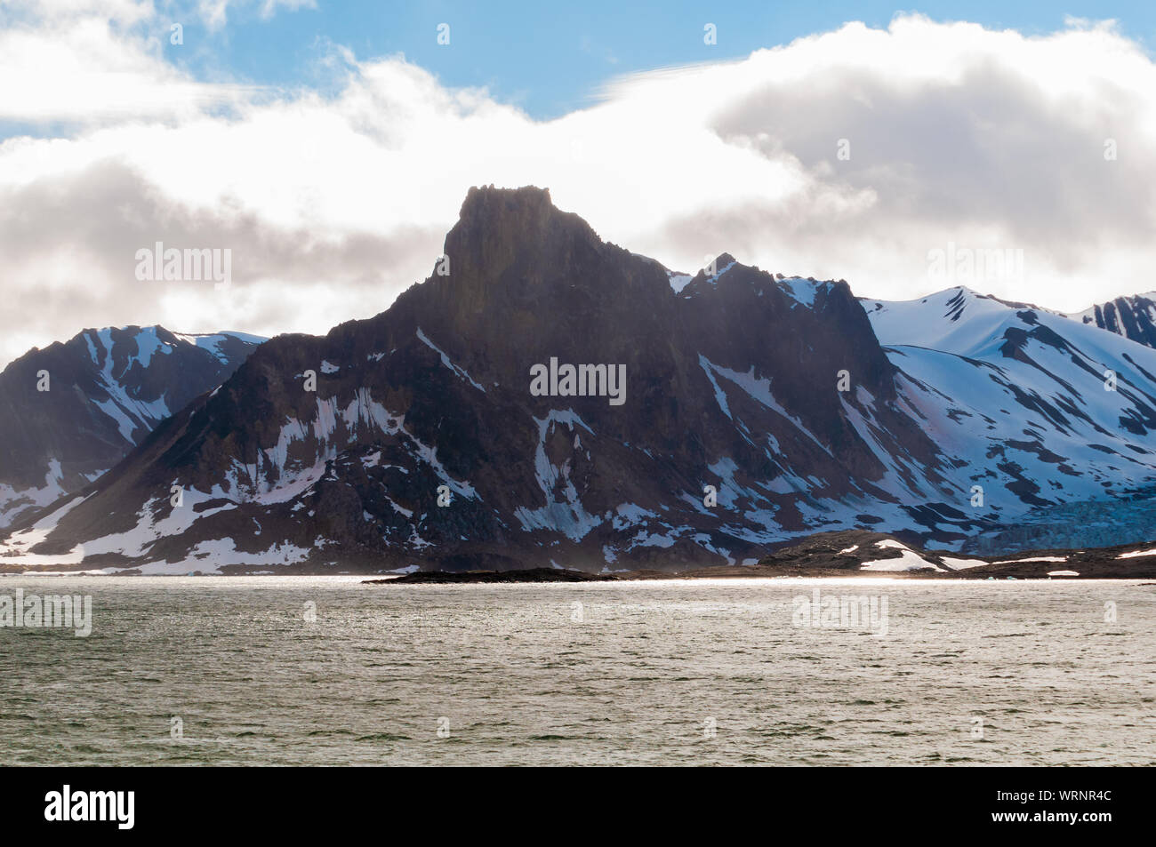Glacier heading down from a mountain range into the Arctic Ocean ...