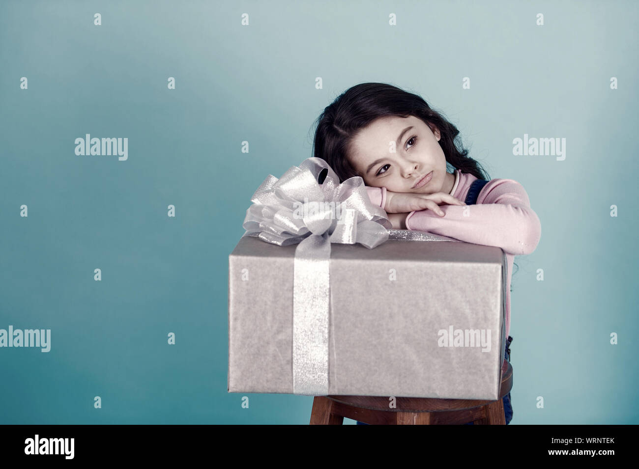 Box with ribbon bow and little girl. Box with present or gift Stock ...