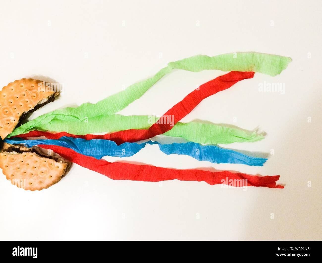 Broken Biscuit With Streamers Over White Background Stock Photo - Alamy