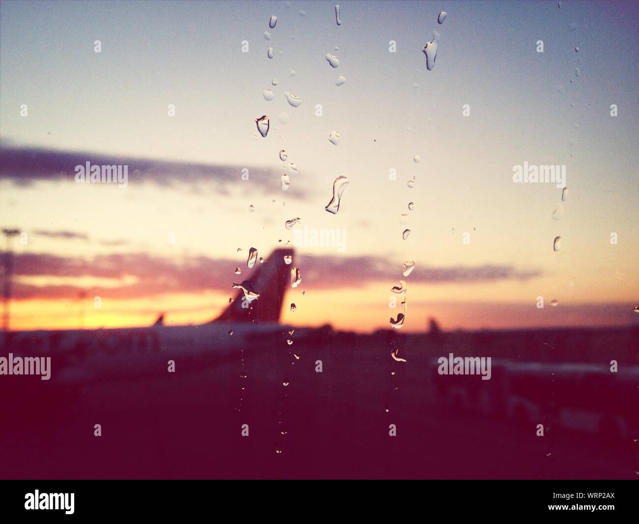 Water Drops On Glass With Airplane At Runway Stock Photo - Alamy