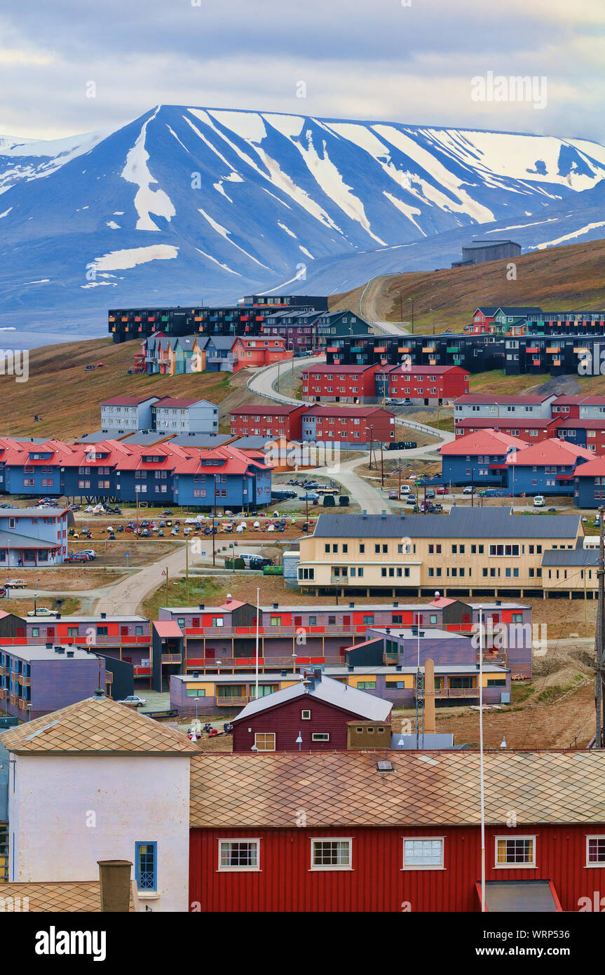 Looking over numerous colorful buildings in the village of Longyearbyen ...