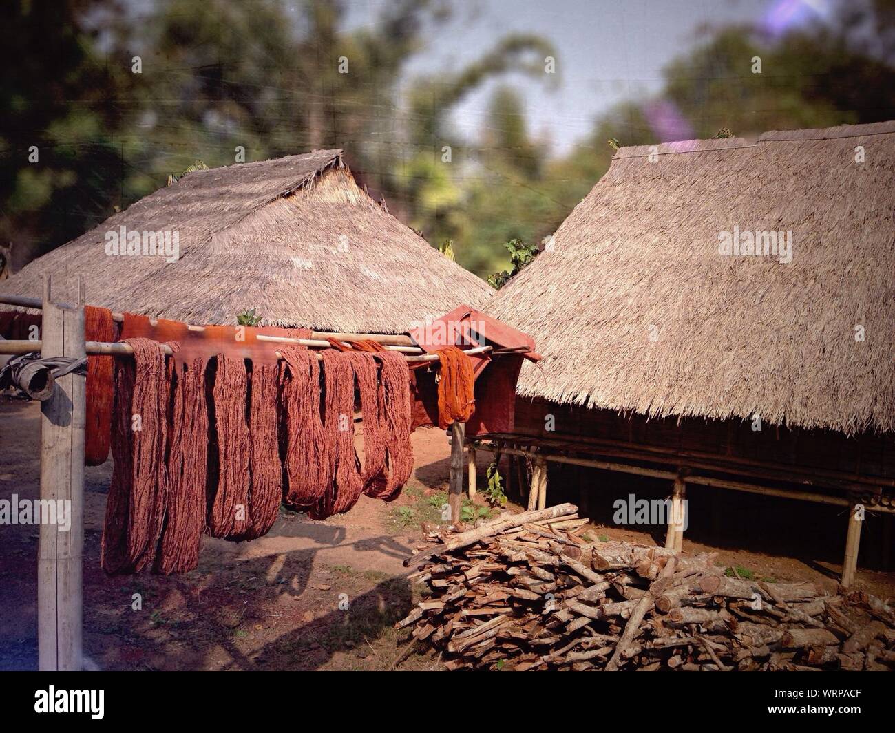 Cotton Fabrics Kept For Drying In Front Of Thatched Roof House Stock ...