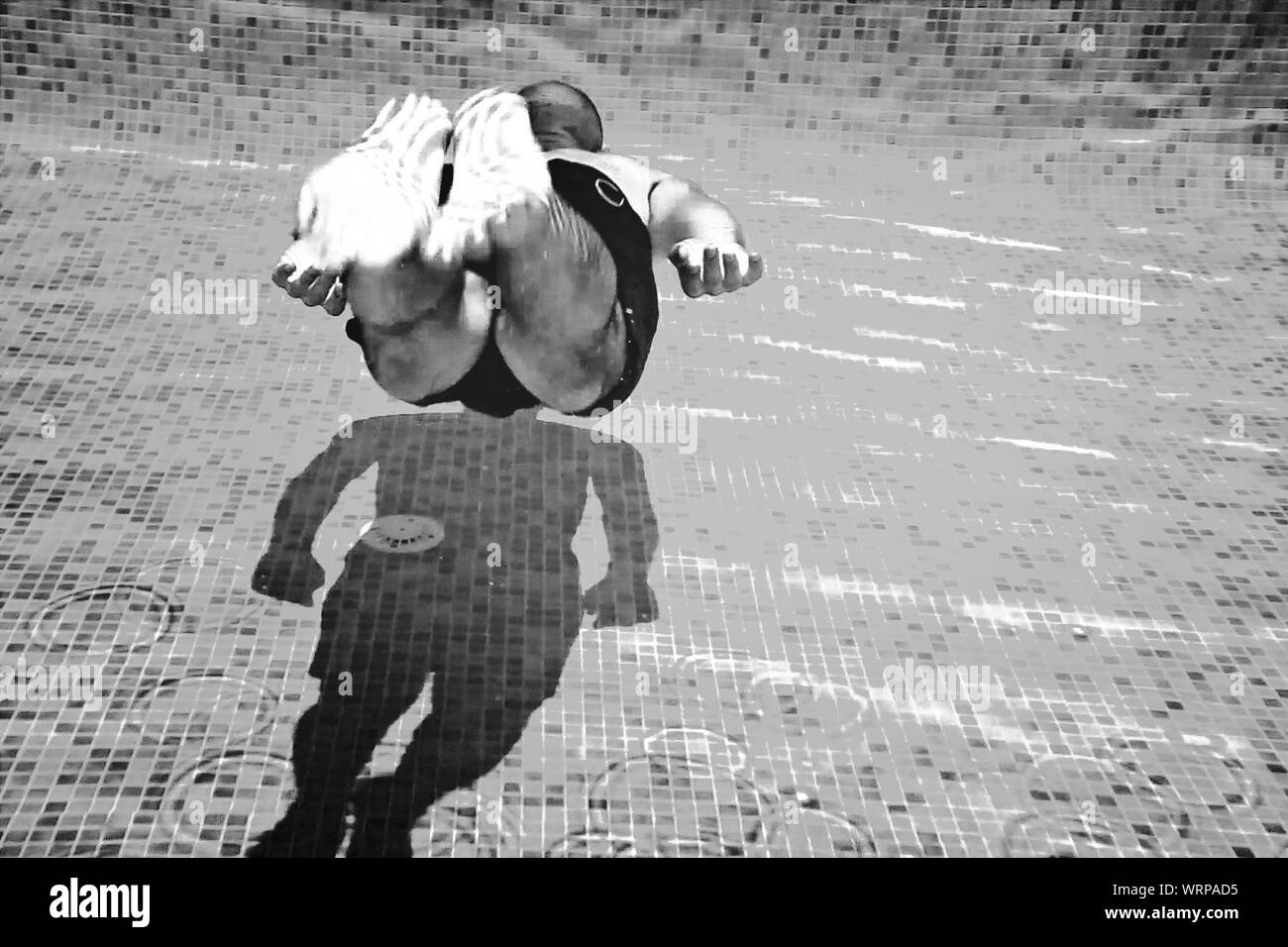 Man jumping in swimming pool Black and White Stock Photos & Images - Alamy