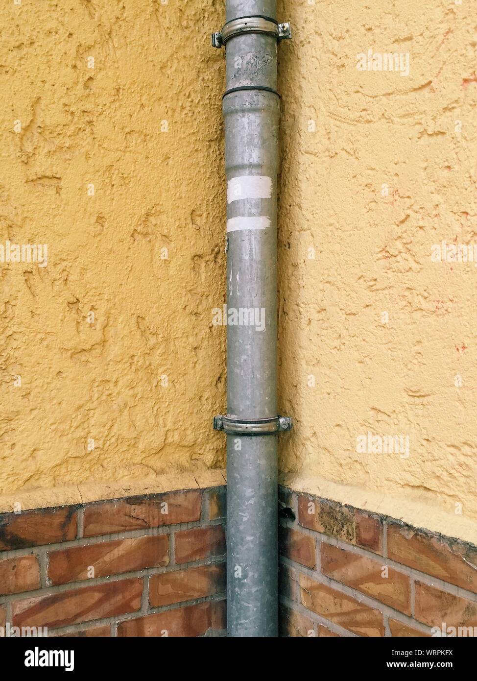Pipe At Corner Against Wall Stock Photo - Alamy