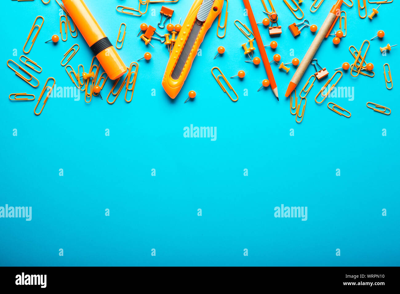 School and office supplies frame, on blue background with copy space ...